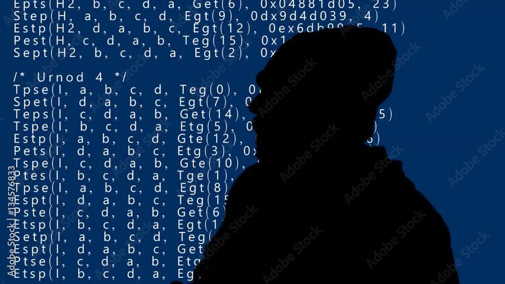 A man looking around through a pair of binoculars. Silhouette over scrolling source code ...