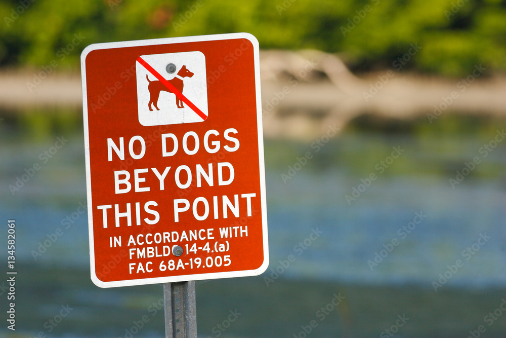 Red sign No dogs beyond this point. Beach near sea water, Florida, USA ...