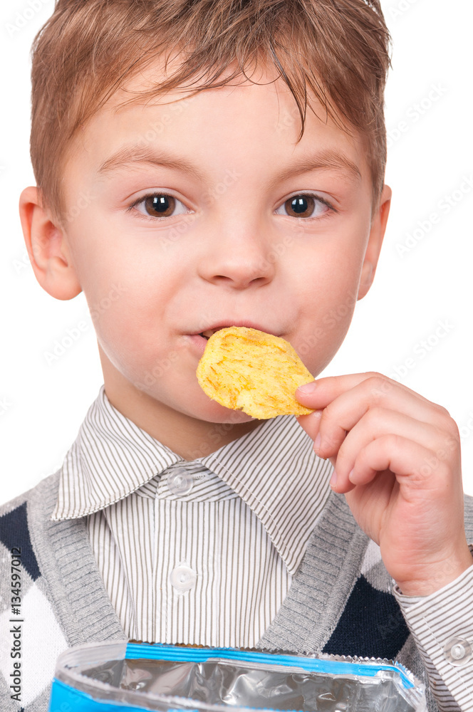 Portrait of cheerful little boy with packet of potato chips. Close-up ...
