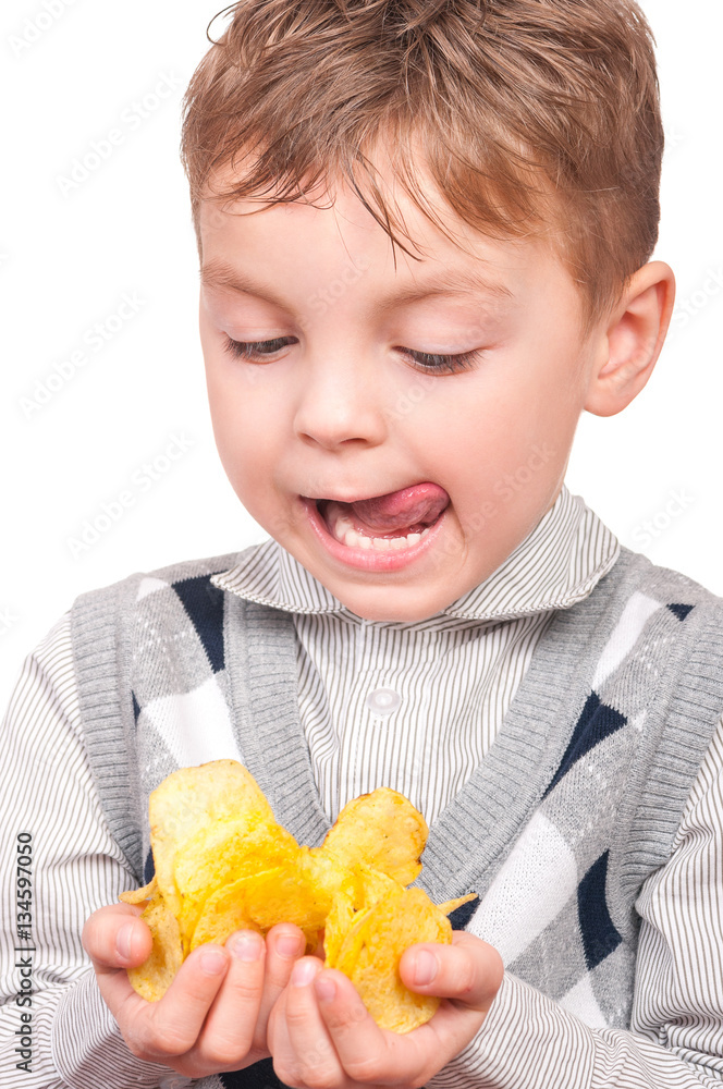 Portrait of cheerful little boy with packet of potato chips. Close-up ...