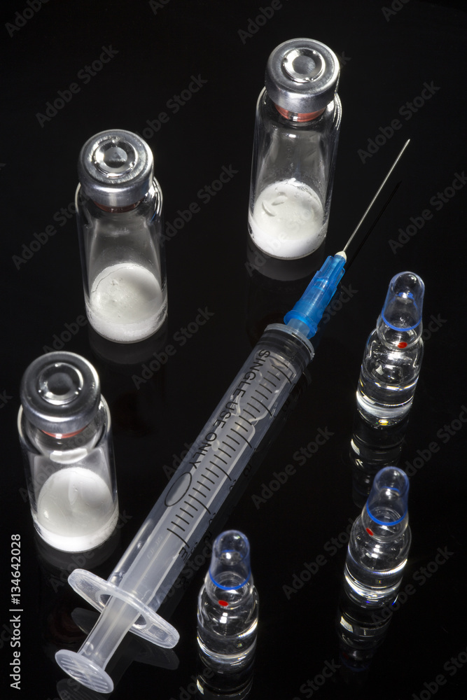 Medical syringe, vials with dry human hormone powder. Syringe with bare ...