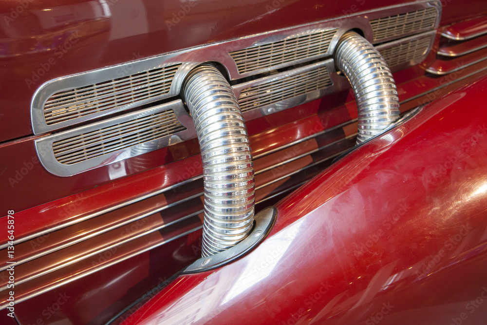 Side exhaust pipes on a classic luxury car Stock Photo | Adobe Stock