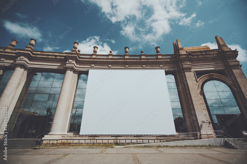 Front view of empty huge mock up banner for your advertising on facade ...