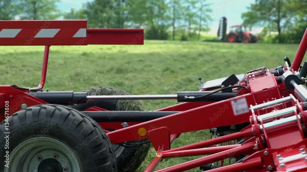 We can see agricultural machinery for preparing hay which is parked ...