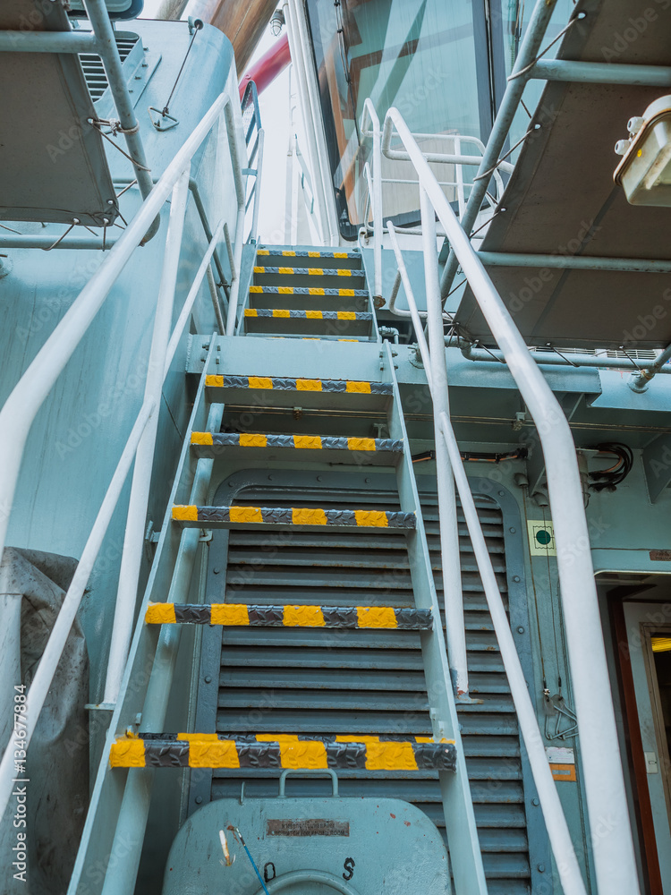Escalator and black-yellow striped warning barrier sticks in a vertical ...