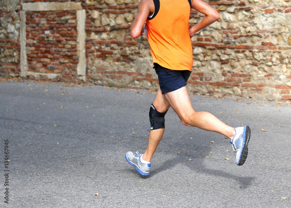 runner running fast with a knee brace to support muscle ligament Stock ...