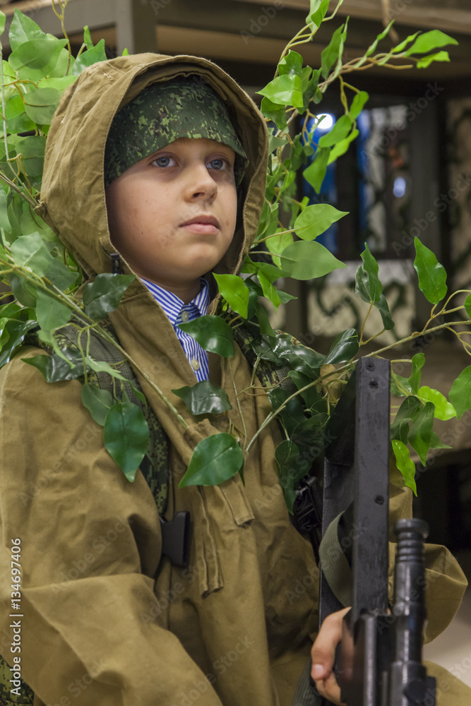 Foto Stock Portrait of a boy scout with a gun | Adobe Stock