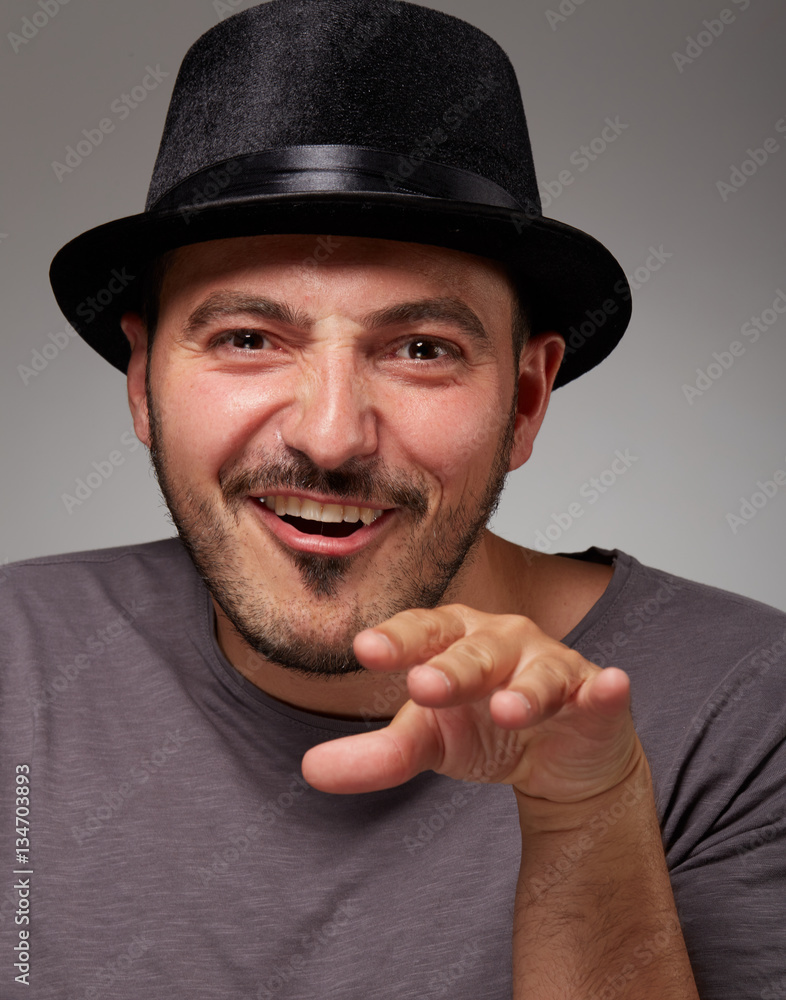 Portrait of a gay man looking at the camera on a gray background Stock ...