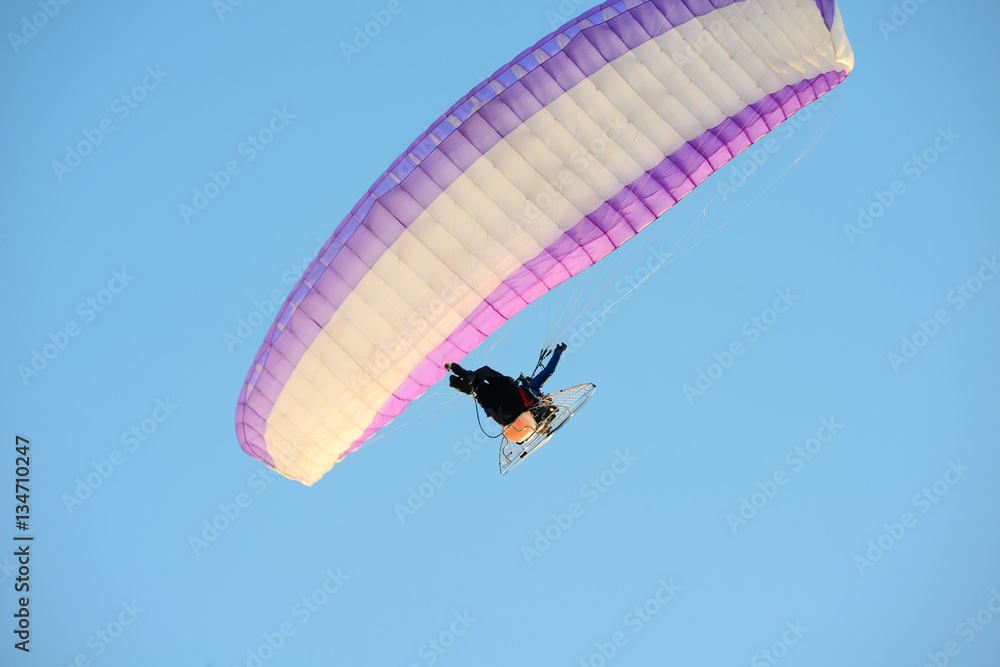 adventure man active extreme sport pilot flying in sky with paramotor ...