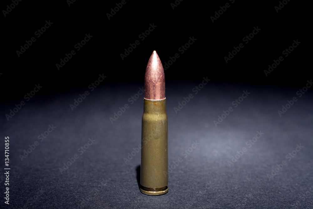 Bullet from kalasnikov rifle ammunition closeup on Black background ...