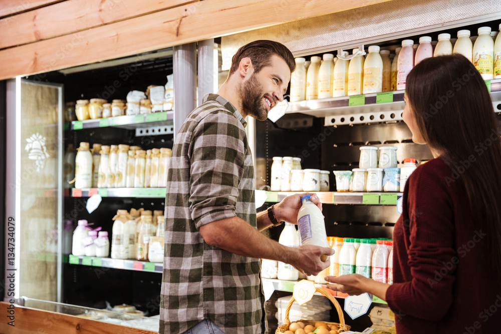Couple buying milk at grocery shop Stock Photo | Adobe Stock
