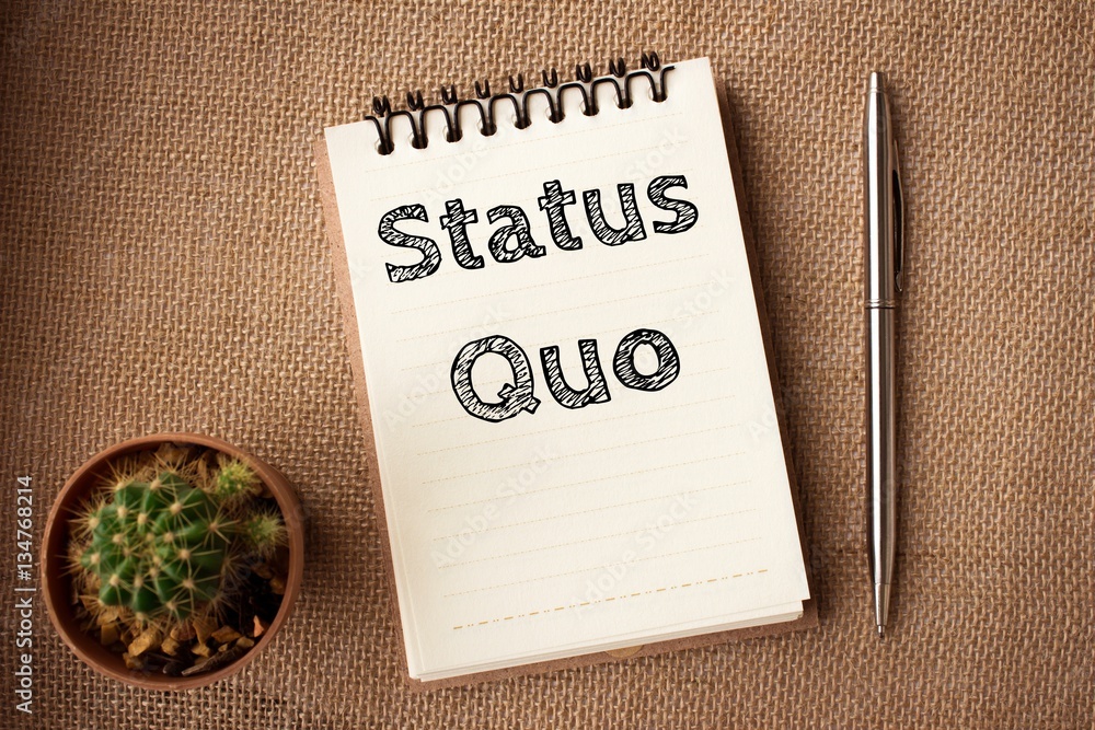 status quo text message on white paper and office supplies, pen, paper ...