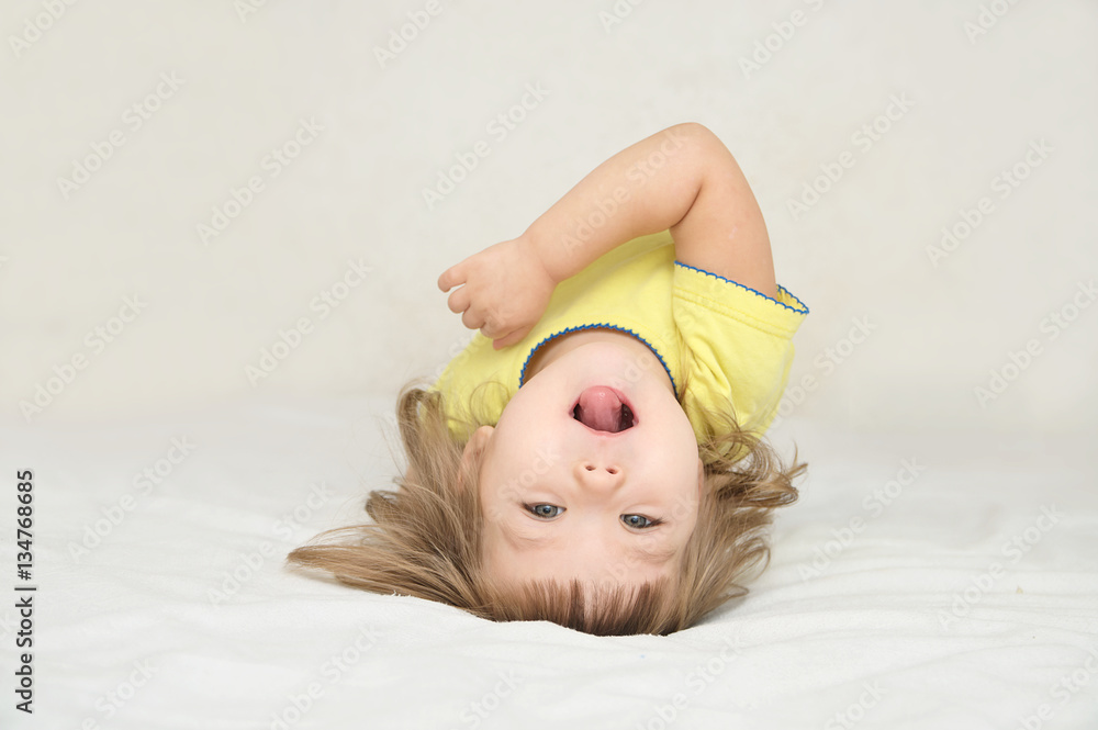 Little girl having fun lying on back spine, back bend, bridge figure ...