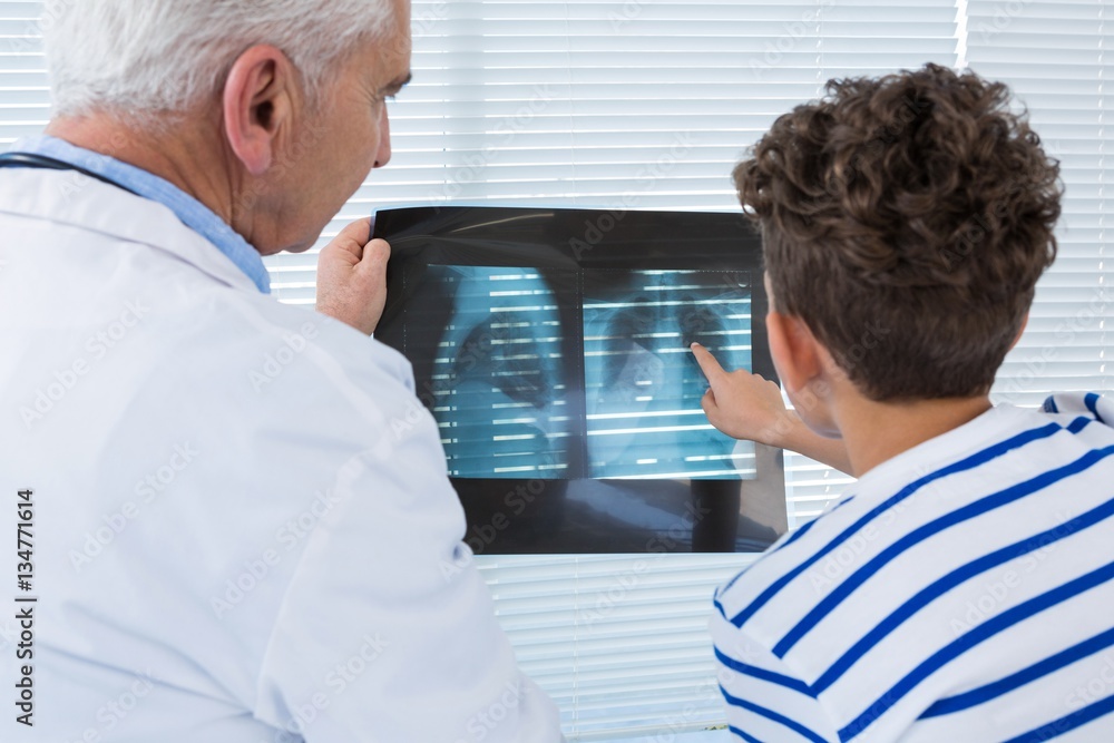 Doctor discussing x-ray report with patient Stock Photo | Adobe Stock