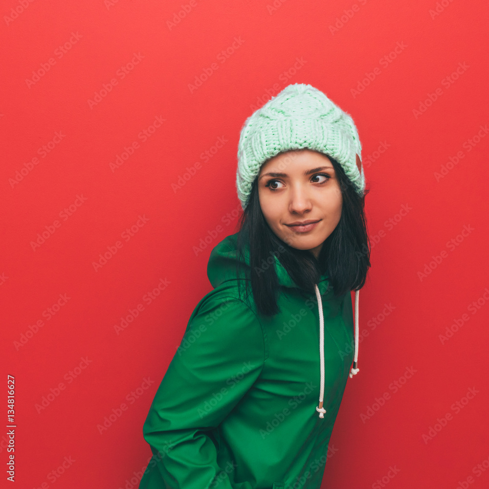 Beautiful woman in fashion pose looking to the side in winter clothing ...