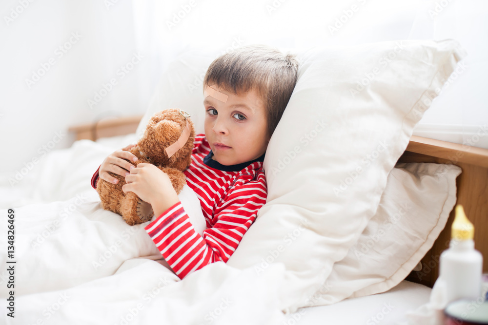 Sick child boy lying in bed with a fever, resting Stock Photo | Adobe Stock