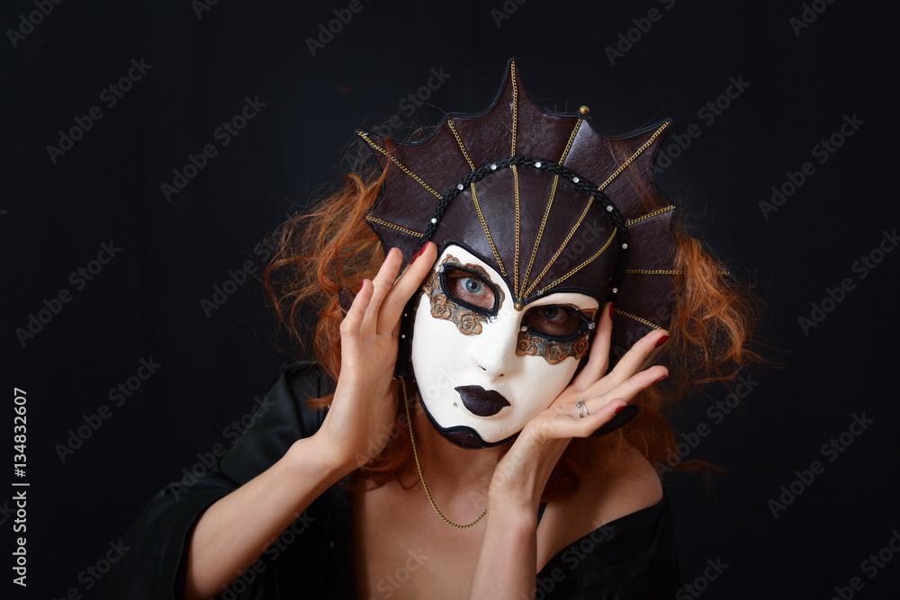 girl with red hair in an old Venetian mask Stock Photo | Adobe Stock