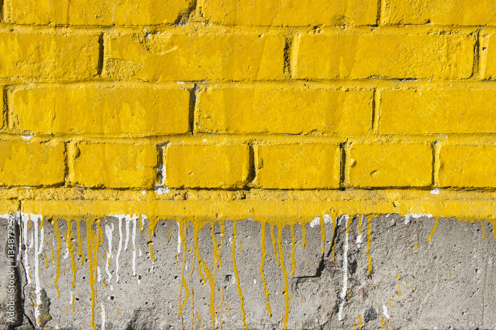 Yellow brick wall with paint stains Stock Photo | Adobe Stock