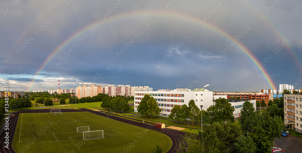 Full 180 rainbow over residental part of Tallinn city, Estonia foto de Stock | Adobe Stock