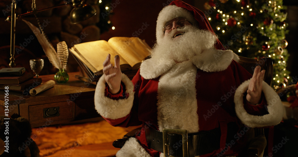 Santa Claus - wearing his full red suit and cap - lets out a belly ...