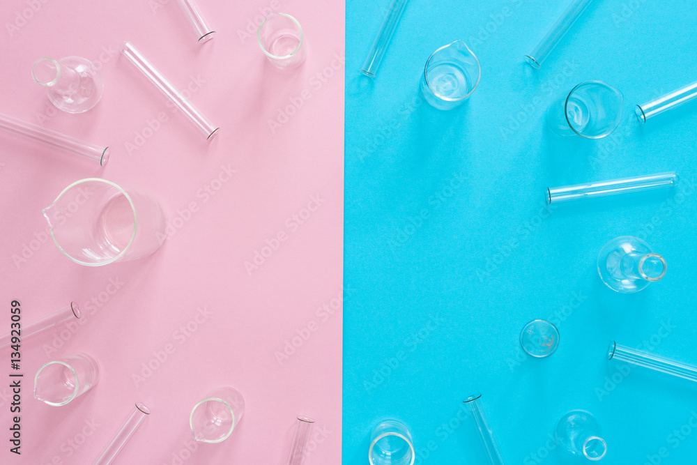 Medical glass test-tubes and beakers pattern top view on pink and blue ...