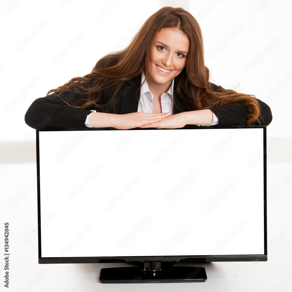 Beautiful young business woman pointing to tv screen with blank space ...