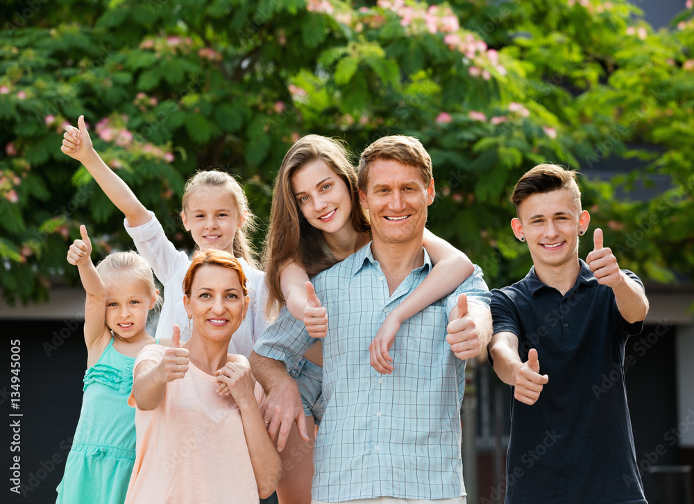 Portrait of large family of six standing and holding thumbs up Stock ...