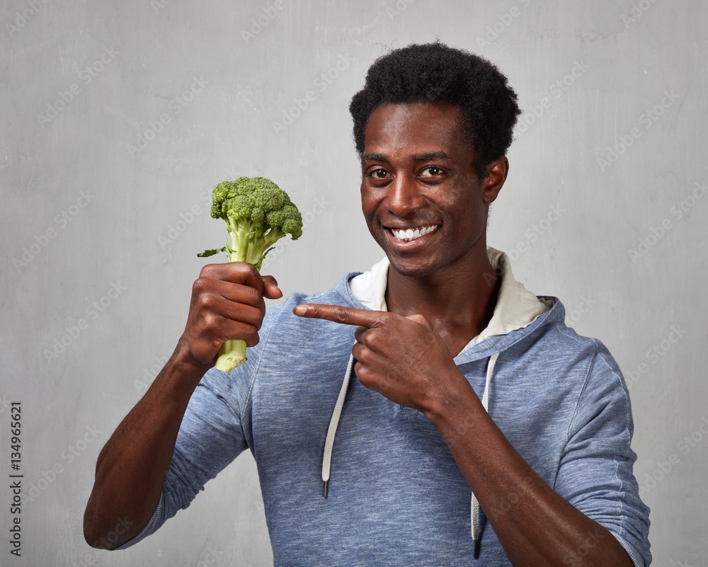 Black man with broccoli Stock Photo | Adobe Stock