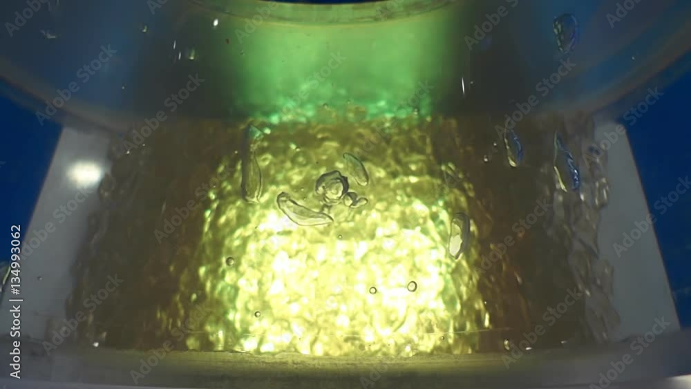 Air bubbles float up from the bottom which highlighted in yellow. Slow ...