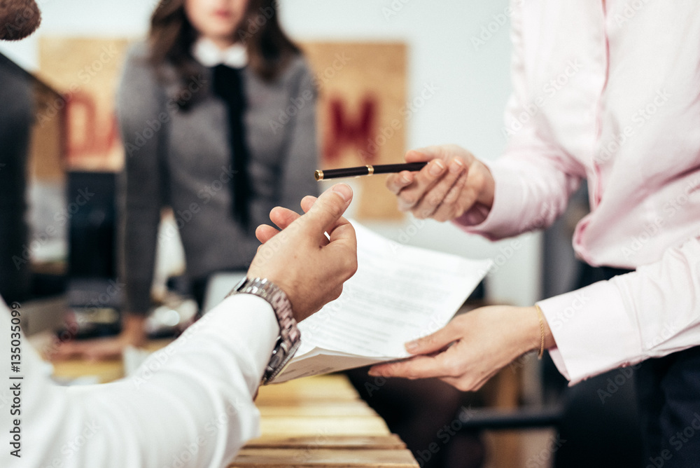 Person giving pen to paper. Stock-Foto | Adobe Stock