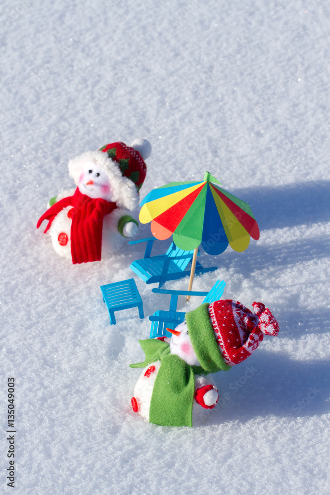Two cute snowman sunbathing in the snow. Paper beach chairs and a ...