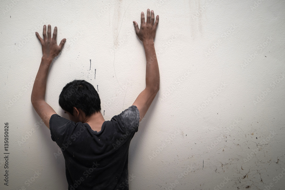 man show hands up facing the wall Stock Photo | Adobe Stock