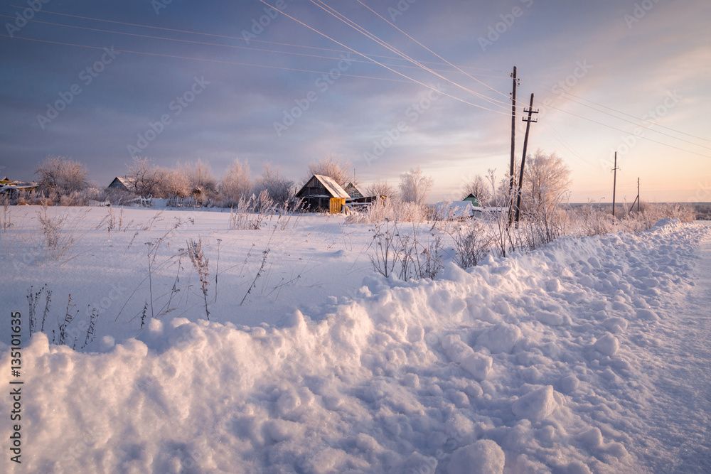 Rural house with a fence in winter. Village after snowfall on road ...