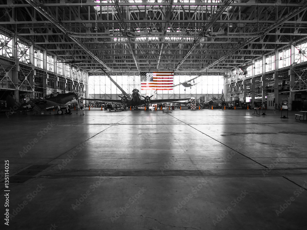 The American flag stands out in the background of this black and white ...