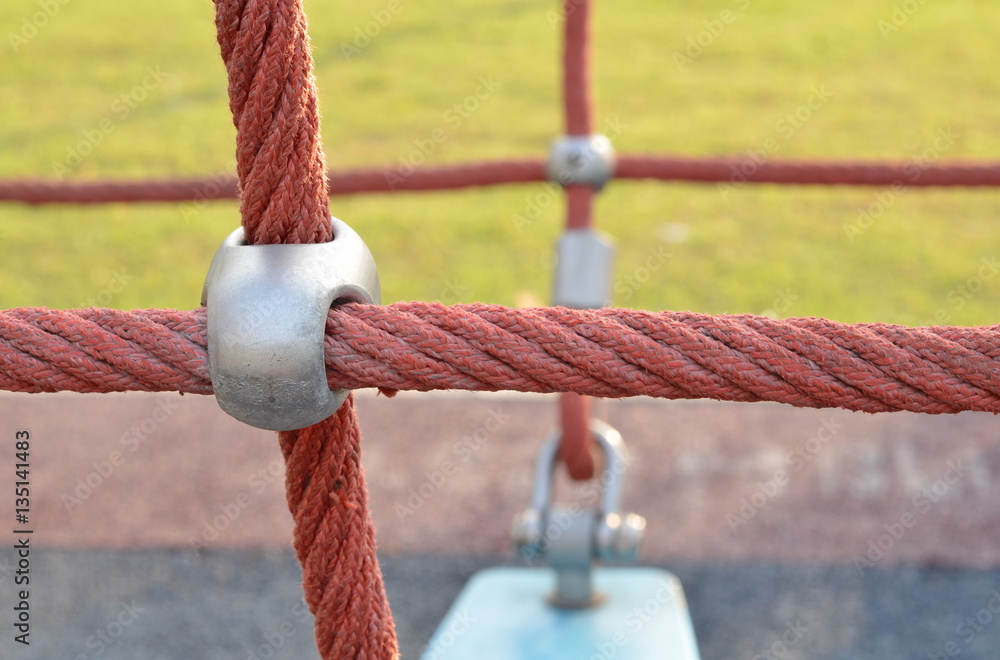 Red rope knot line tied together in the playground,as a symbol for ...