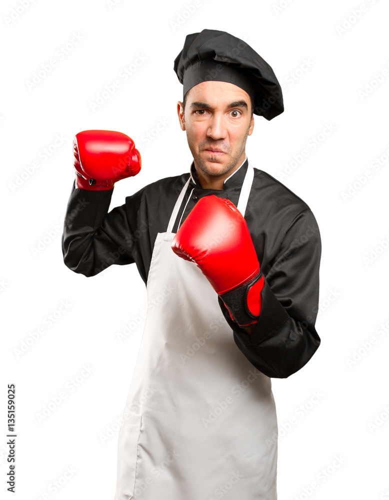 Angry chef using a boxing gloves Stock Photo | Adobe Stock