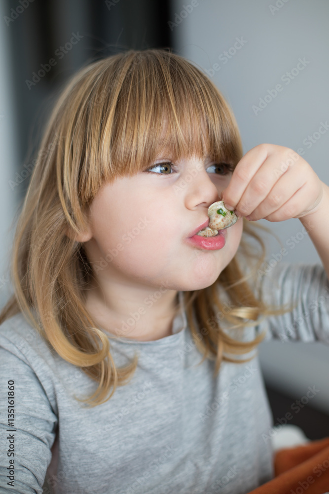 portrait of three years old blonde hungry child face, with grey shirt ...