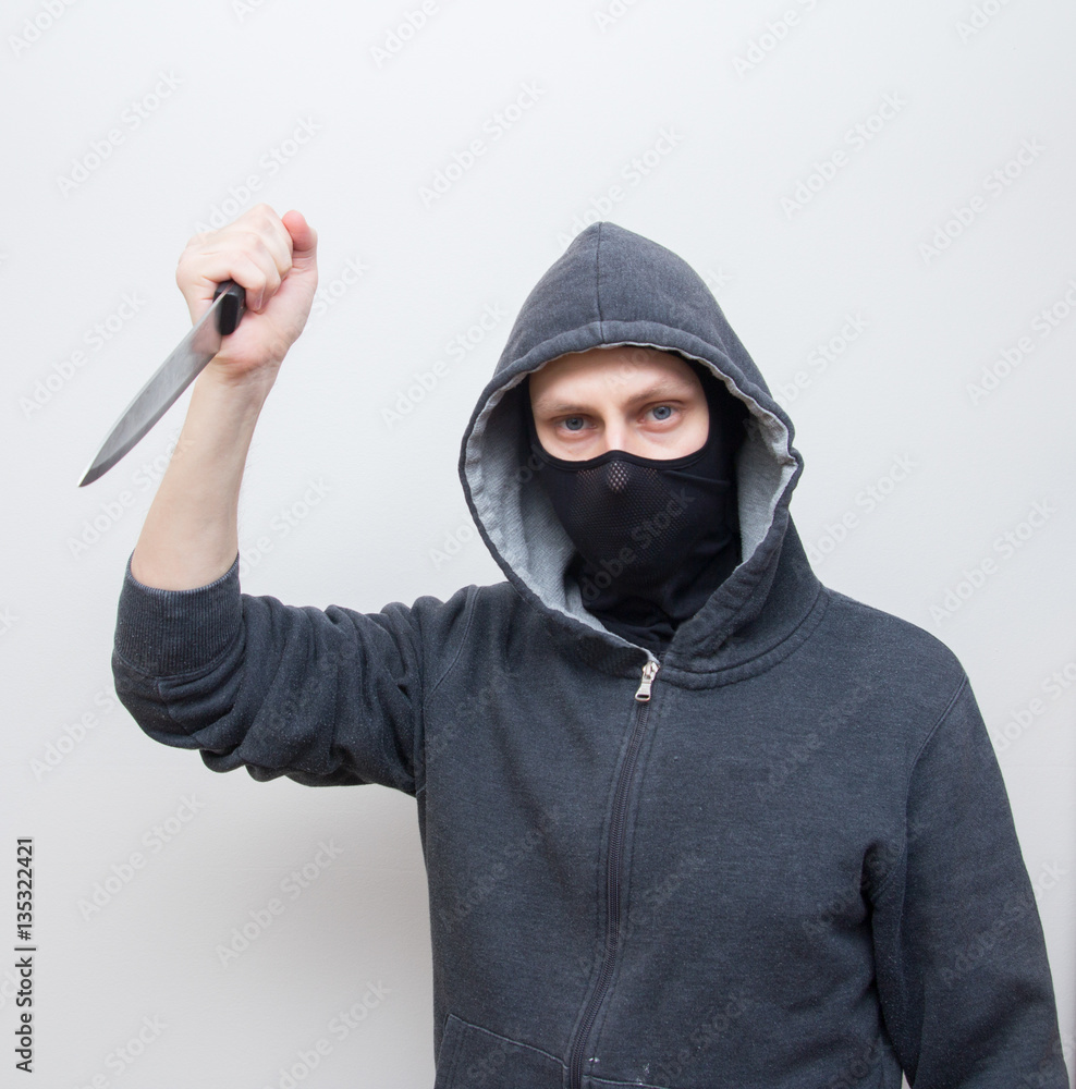 man in ski mask threatening with knife Stock Photo | Adobe Stock