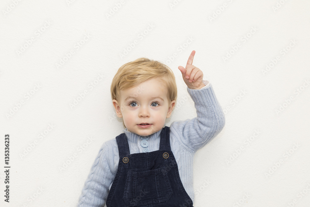 Adorable little child pointing up on white background Stock Photo ...