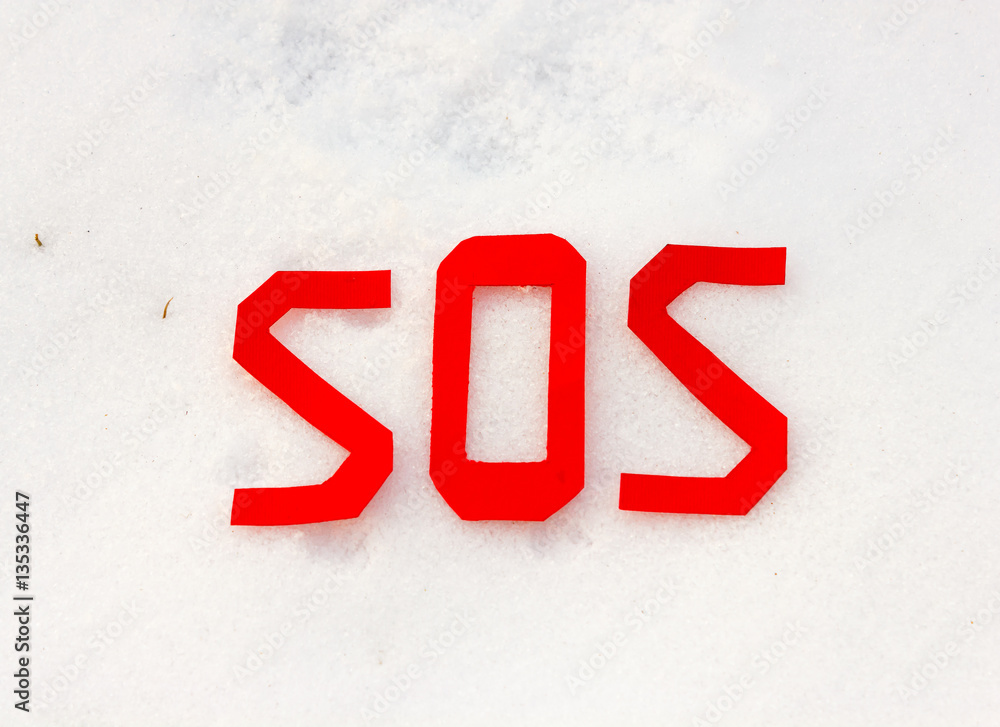 the word sos on a snowfield / the universal distress signal sos on a ...