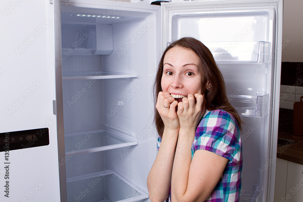 Surprised woman empty fridge Stock Photo | Adobe Stock