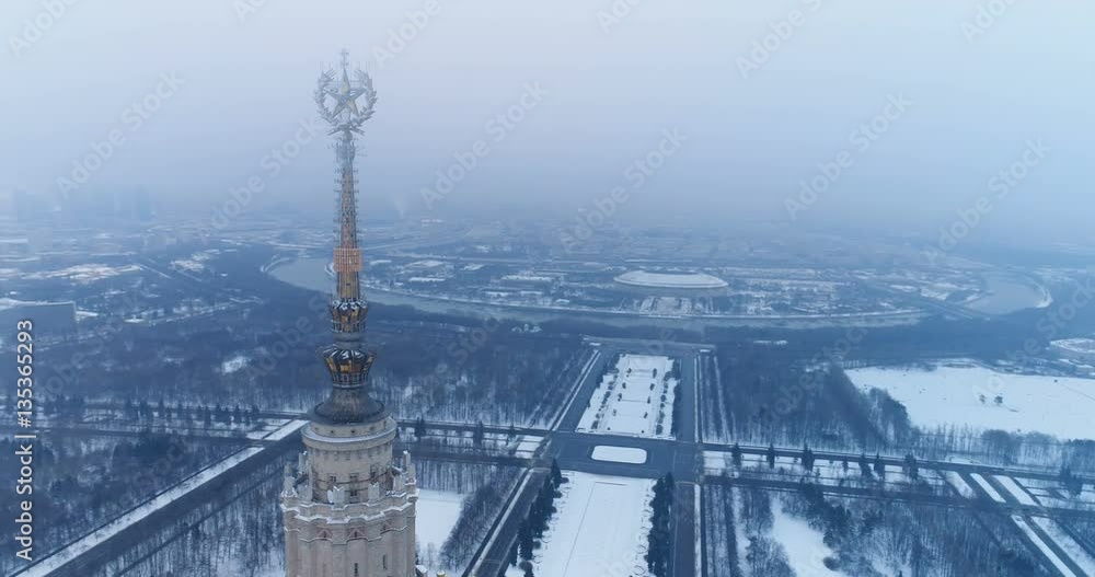 Moscow state university in snowy winter. Aerial view. Flying around ...