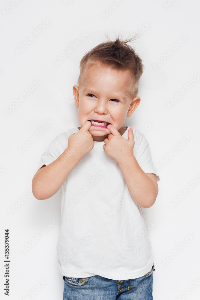 Cute young boy making a funny face against a white background Stock ...