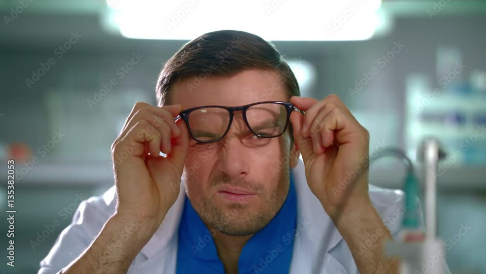 Scientist remove glasses from face. Scientist looking at glasses. Man ...