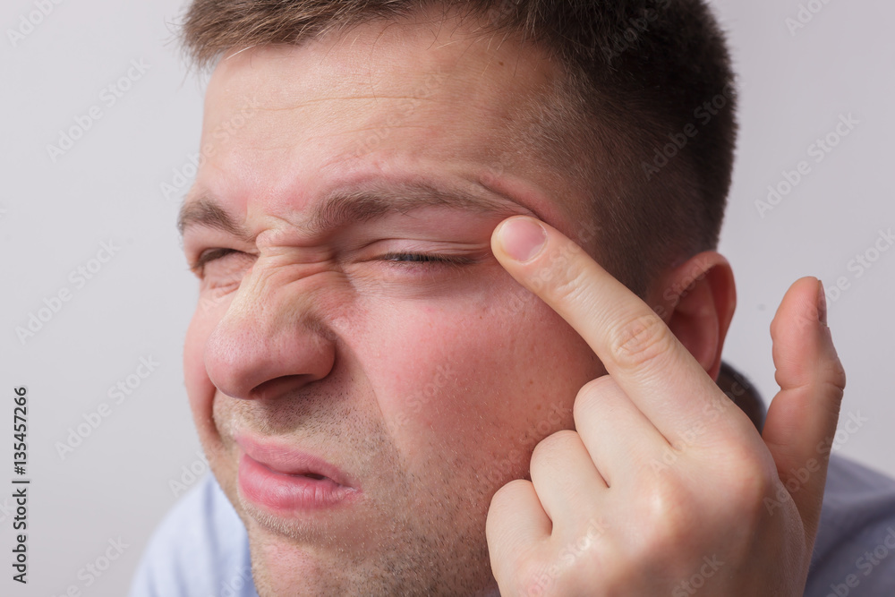 Young man squinting, trying to review the information closer Stock ...