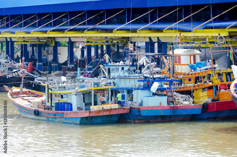 JOHOR, MALAYSIA - JANUARY 30, 2017: Fishing boats anchored at the jetty ...