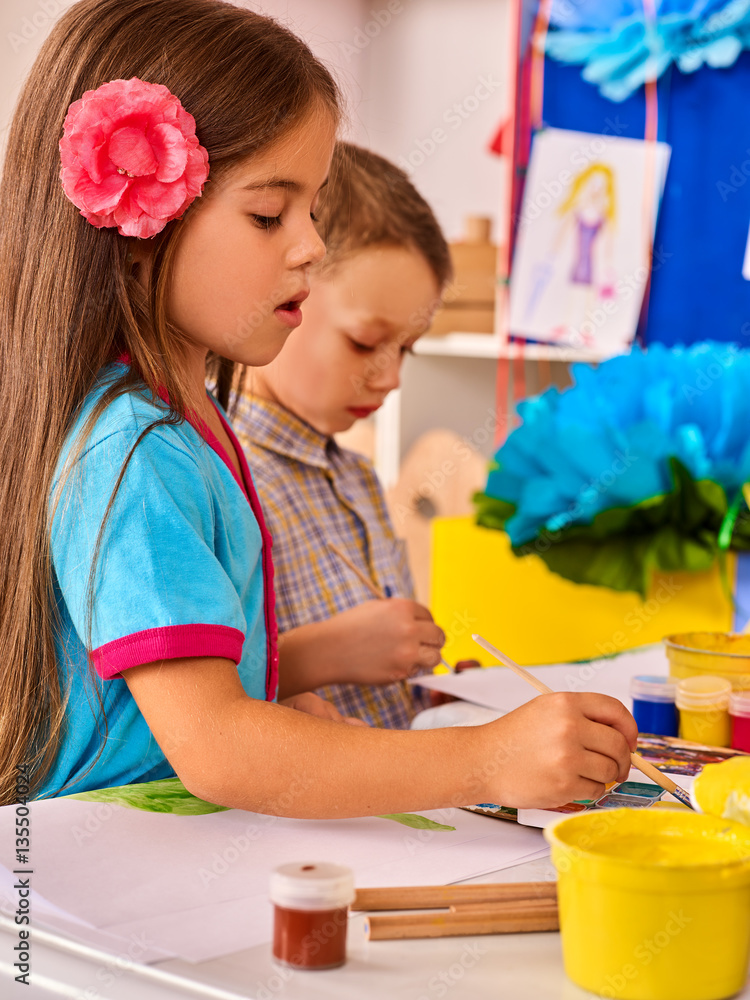 Small students painting in art school class. Child drawing by paints on ...