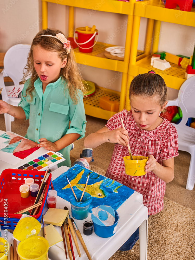 Small Students Painting In Art School Class Child Drawing By Paints On