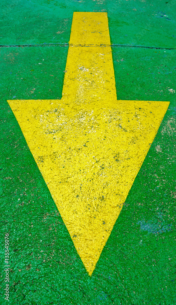 Big yellow arrow on the green background pointing down Stock Photo ...