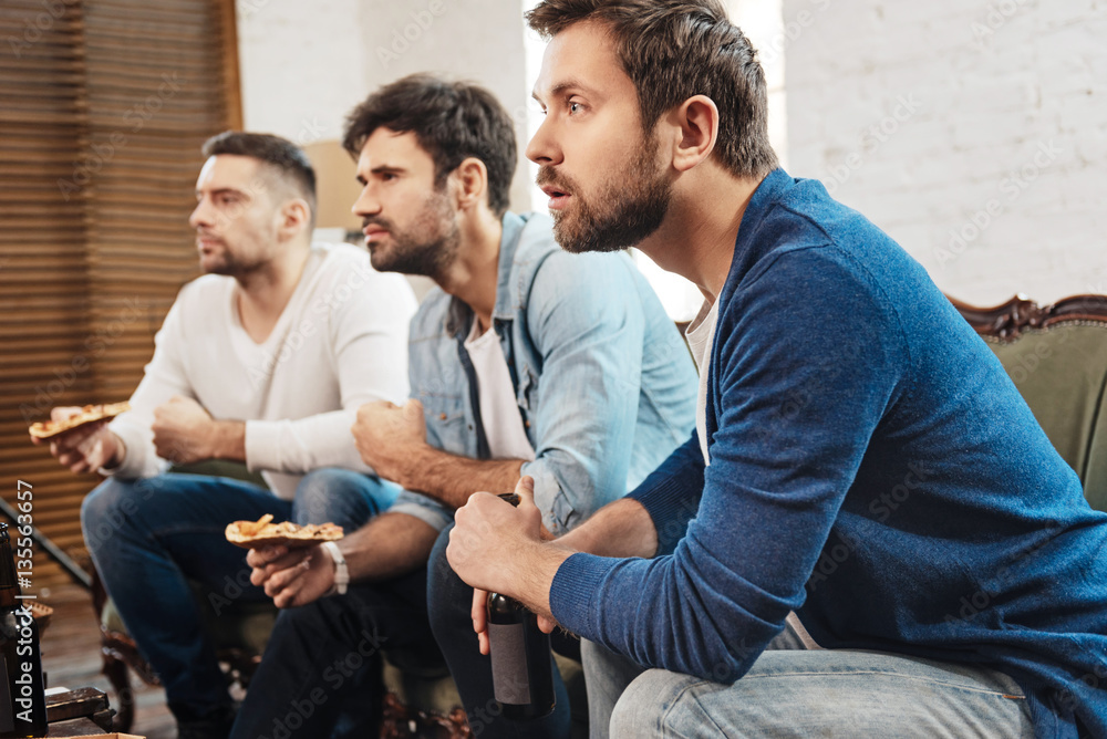 Serious concentrated men watching a football match Stock-Foto | Adobe Stock